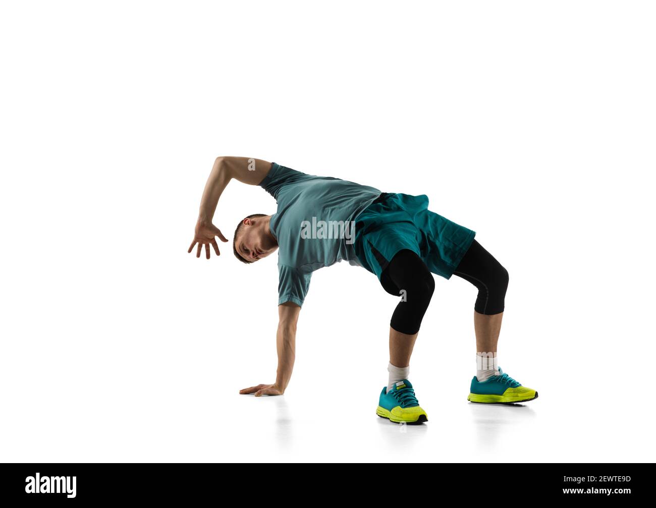 Stretching. Young caucasian male model in action, motion isolated on ...