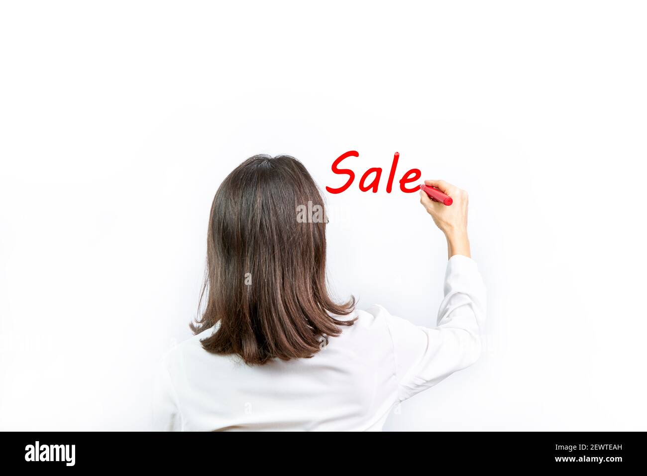 Female executive writing the word sale in red on a white background ...