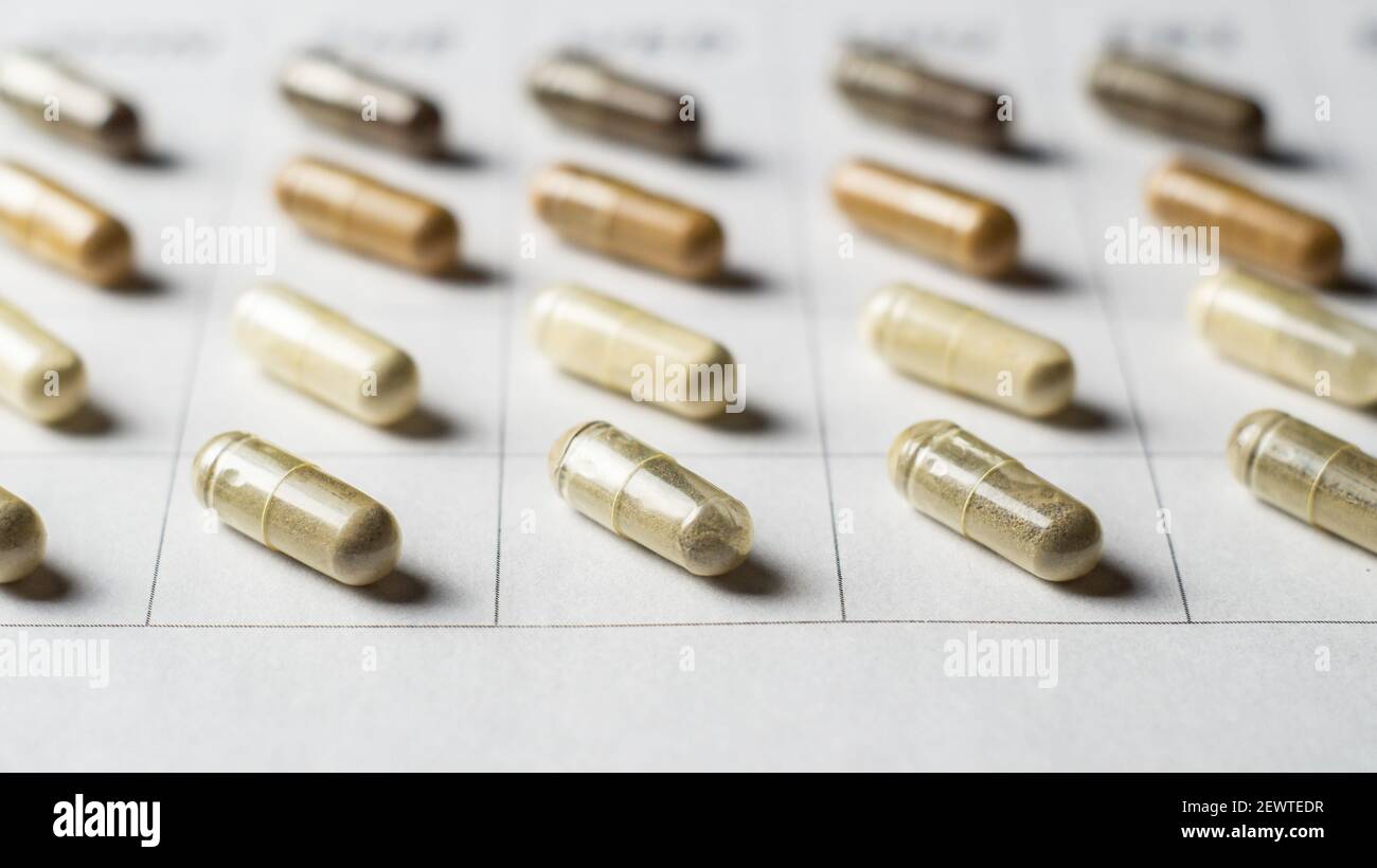 Medication capsules or dietary supplements on the treatment schedule ...