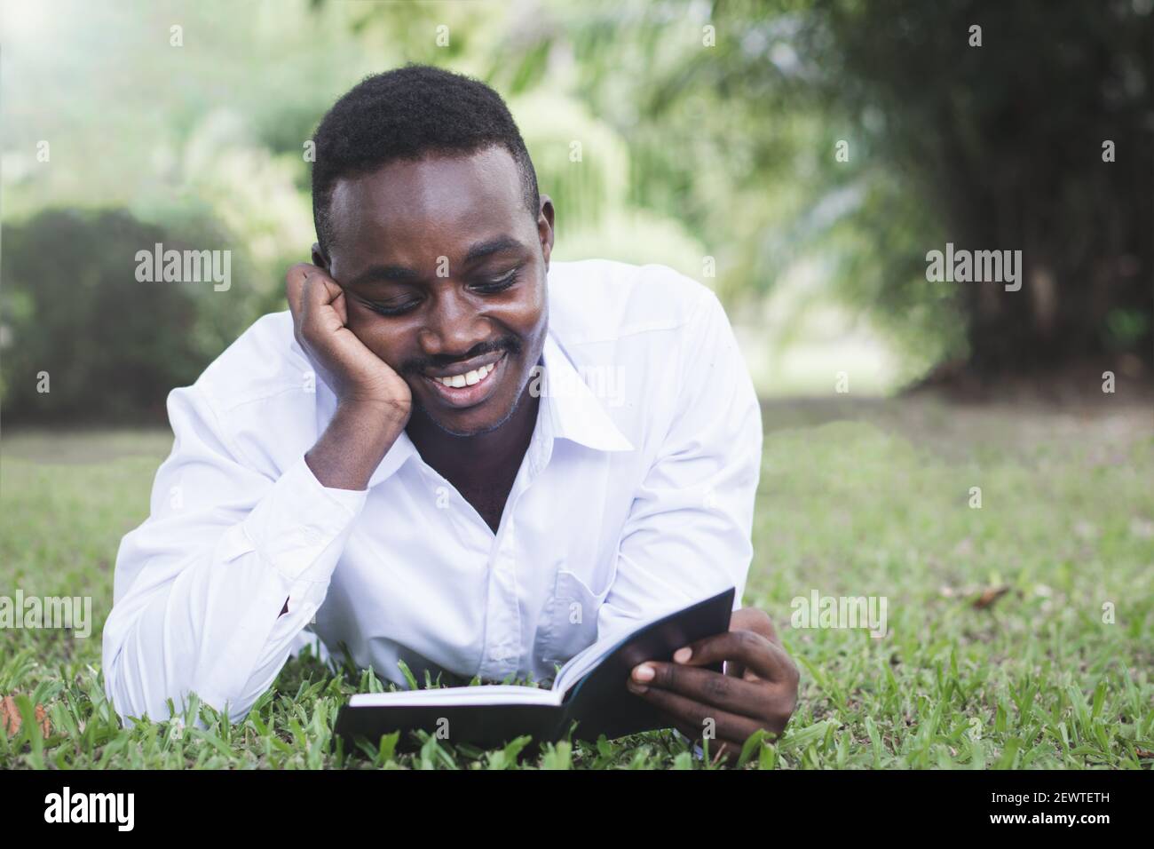 African Man Reading A Book High Resolution Stock Photography and Images ...