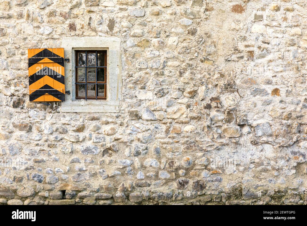 Minimalist photo of a castle window, with a black and yellow shutter ...