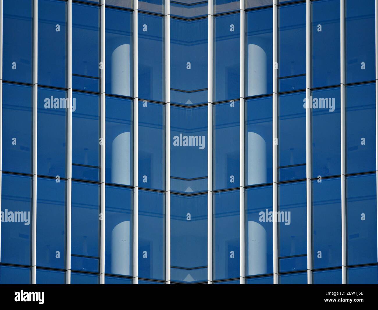 Corporate offices high-rise building blue glass facade with reflections ...