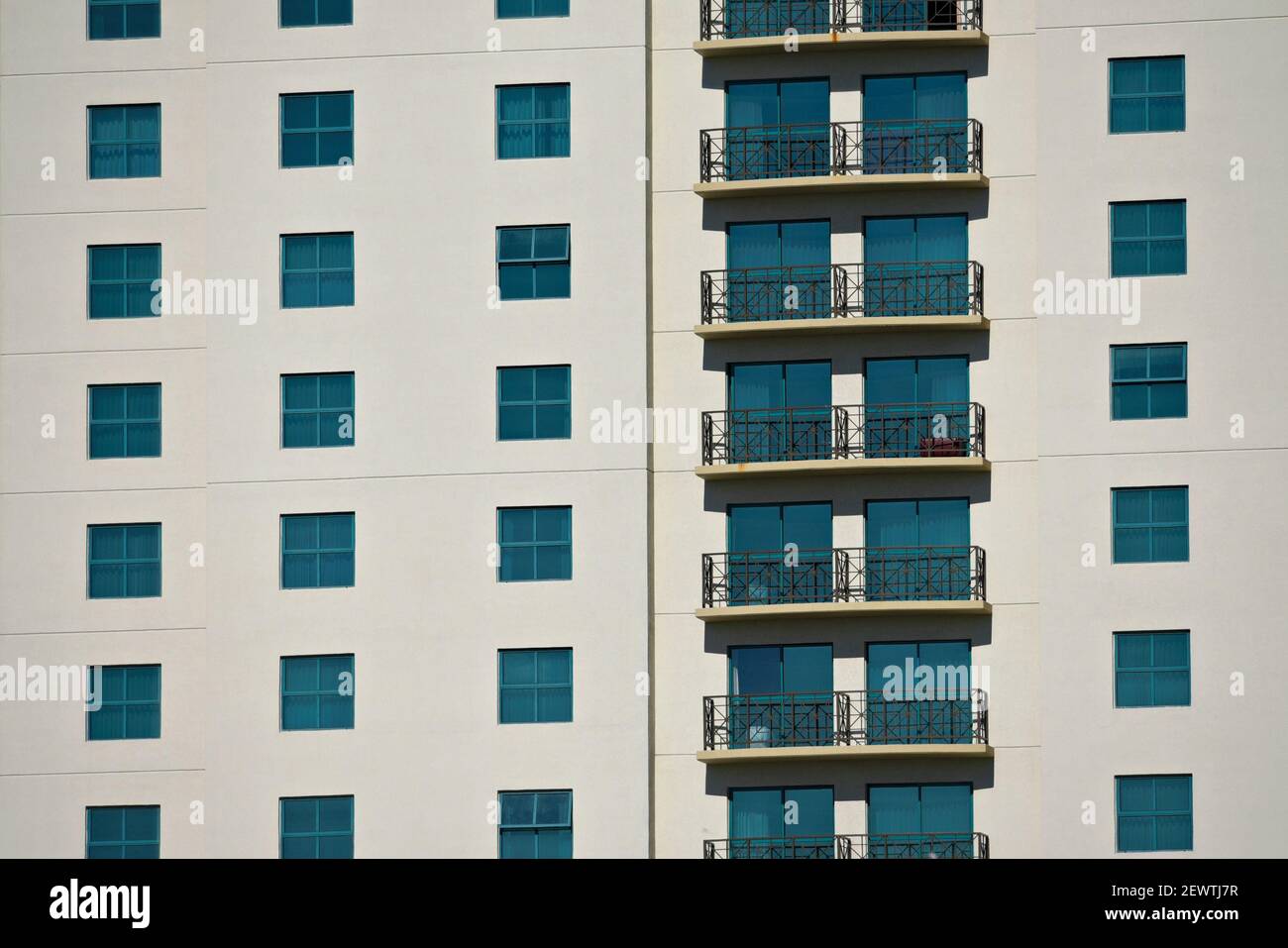 Modern design high-rise building white concrete walls and symmetrical ...