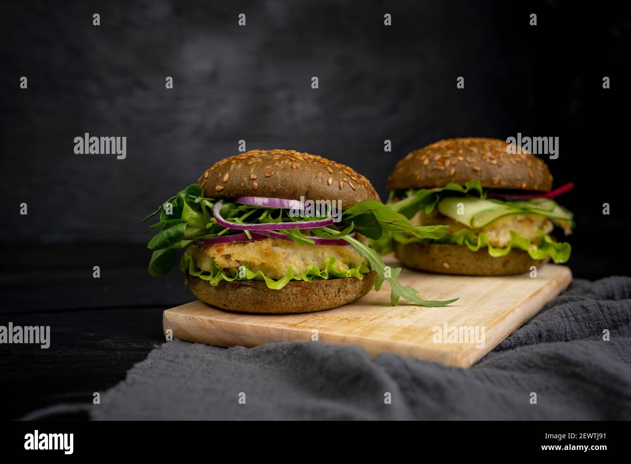 Vegetarian American Cuisine. Burger with fish, arugula, cucumbers ...