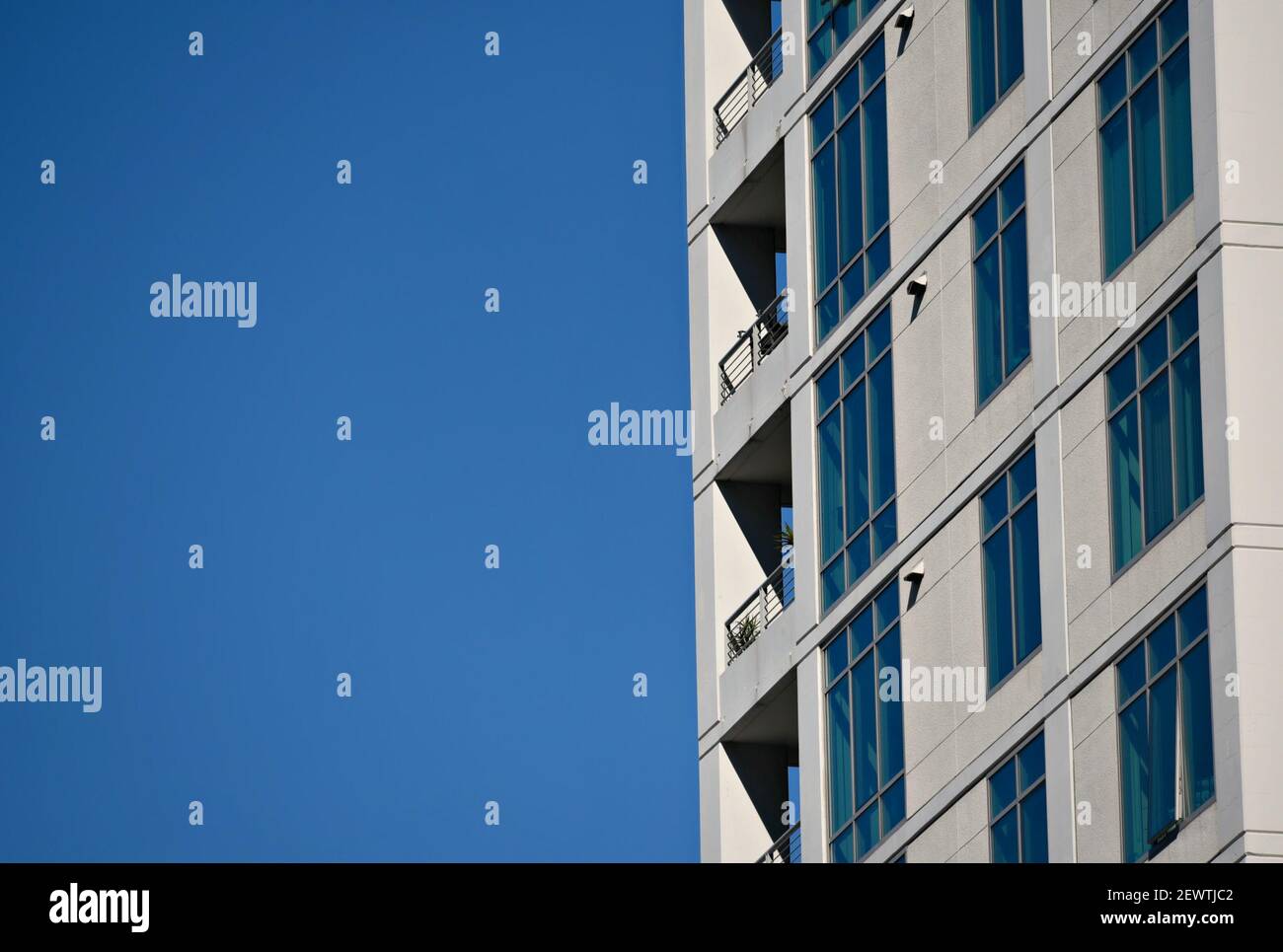Commercial high-rise building white concrete and glass facade in San ...
