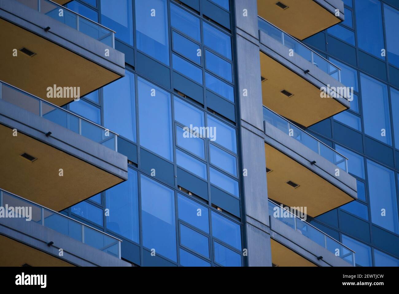 Condominiums high-rise building facade with symmetrical blue glass ...