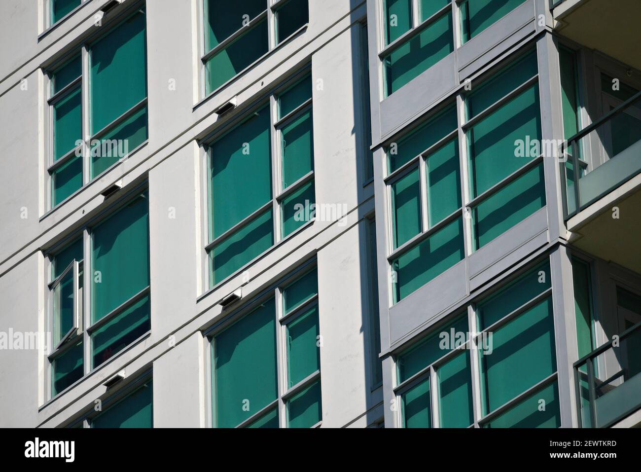 Corporate offices high-rise building facade with symmetrical green ...