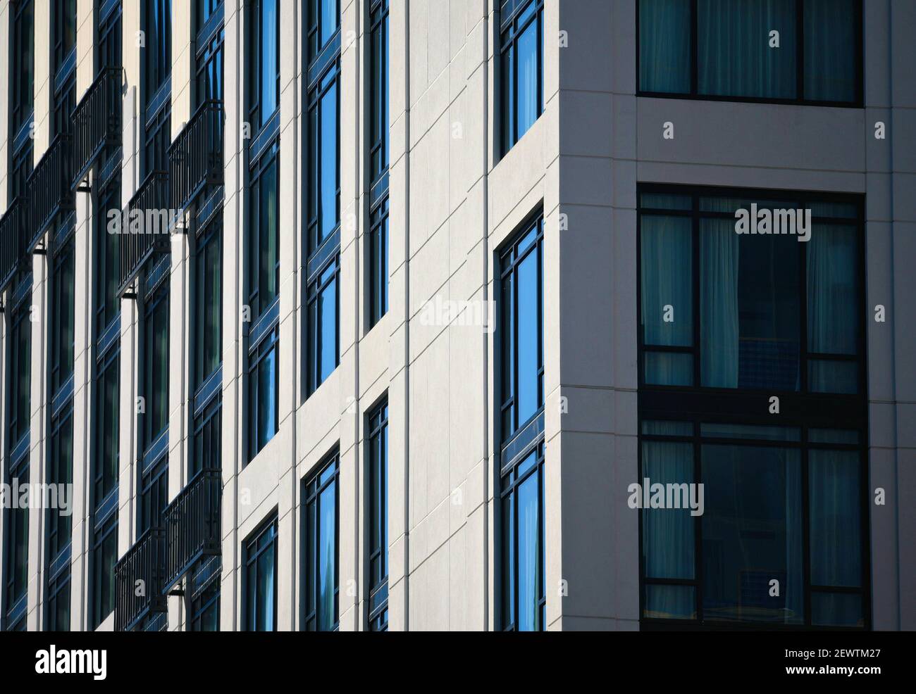 Commercial high-rise building white concrete and glass facade in San ...