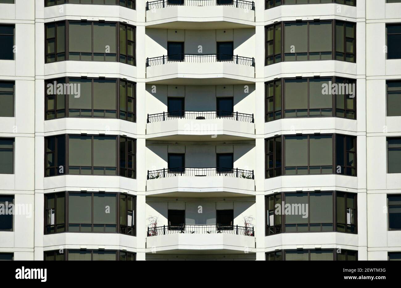 Modern design high-rise building white concrete walls and symmetrical ...