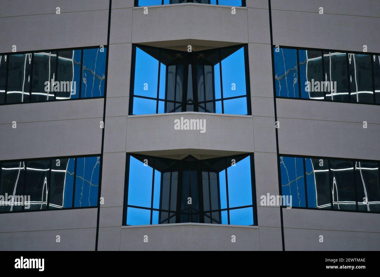 Modern design high-rise building facade with a grey concrete wall and ...