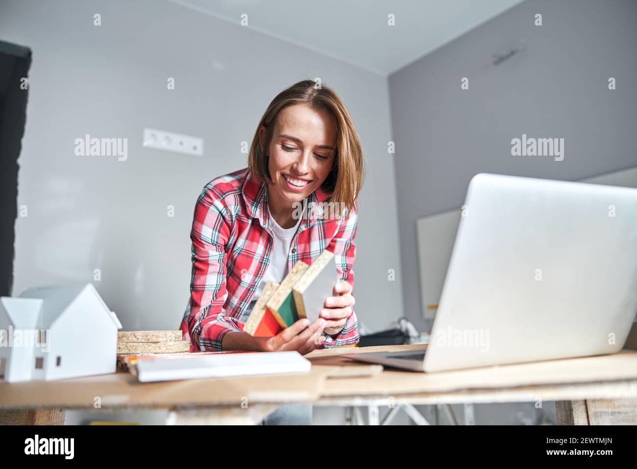 Interior designer examining paint samples on the medium-density ...