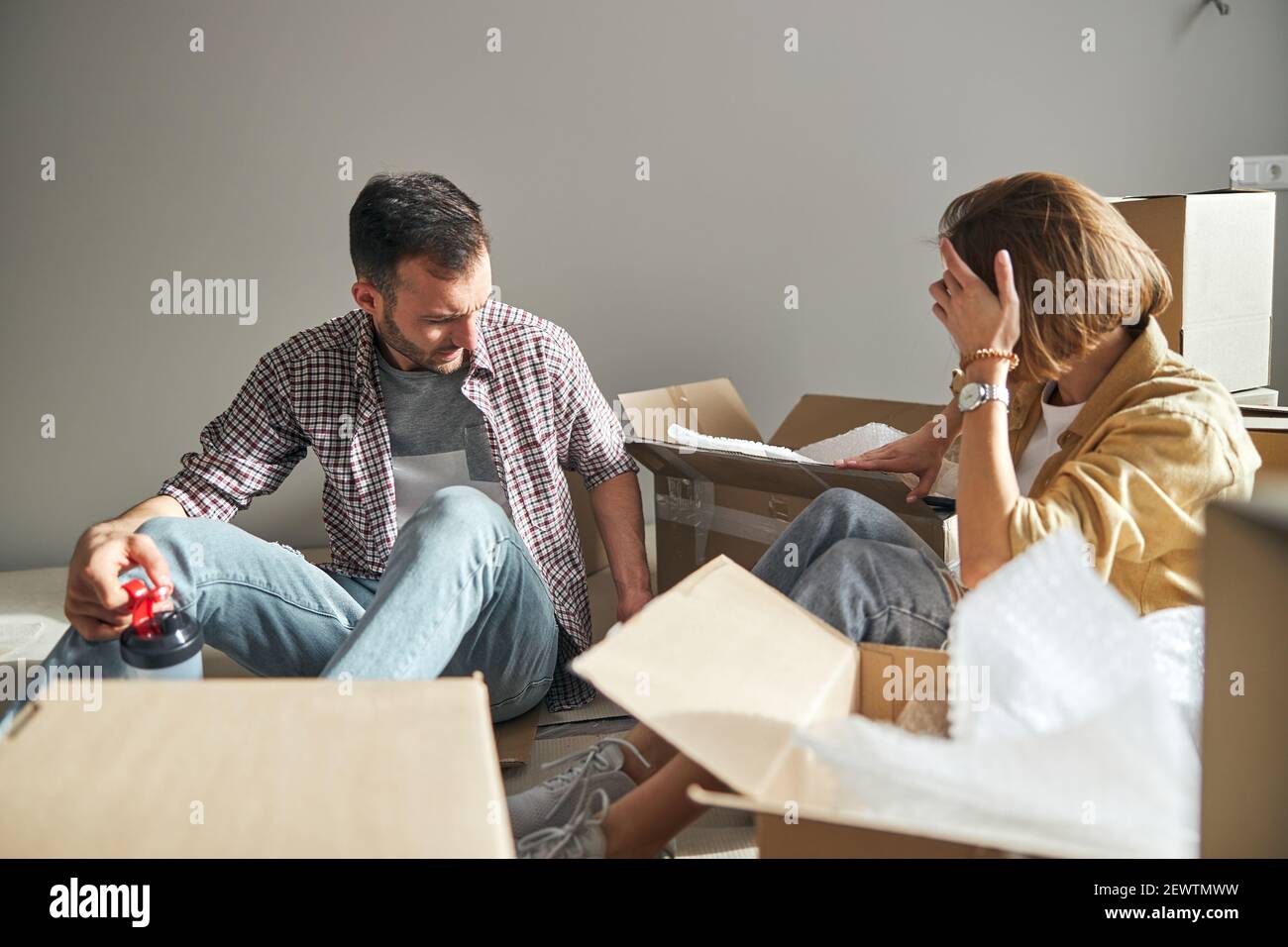 Couple searching for something among open cardboard boxes Stock Photo ...