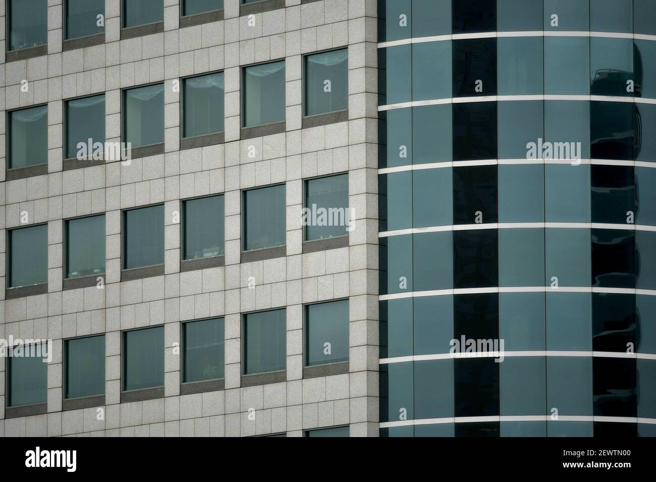 Corporate offices high-rise building facade with symmetrical glass ...
