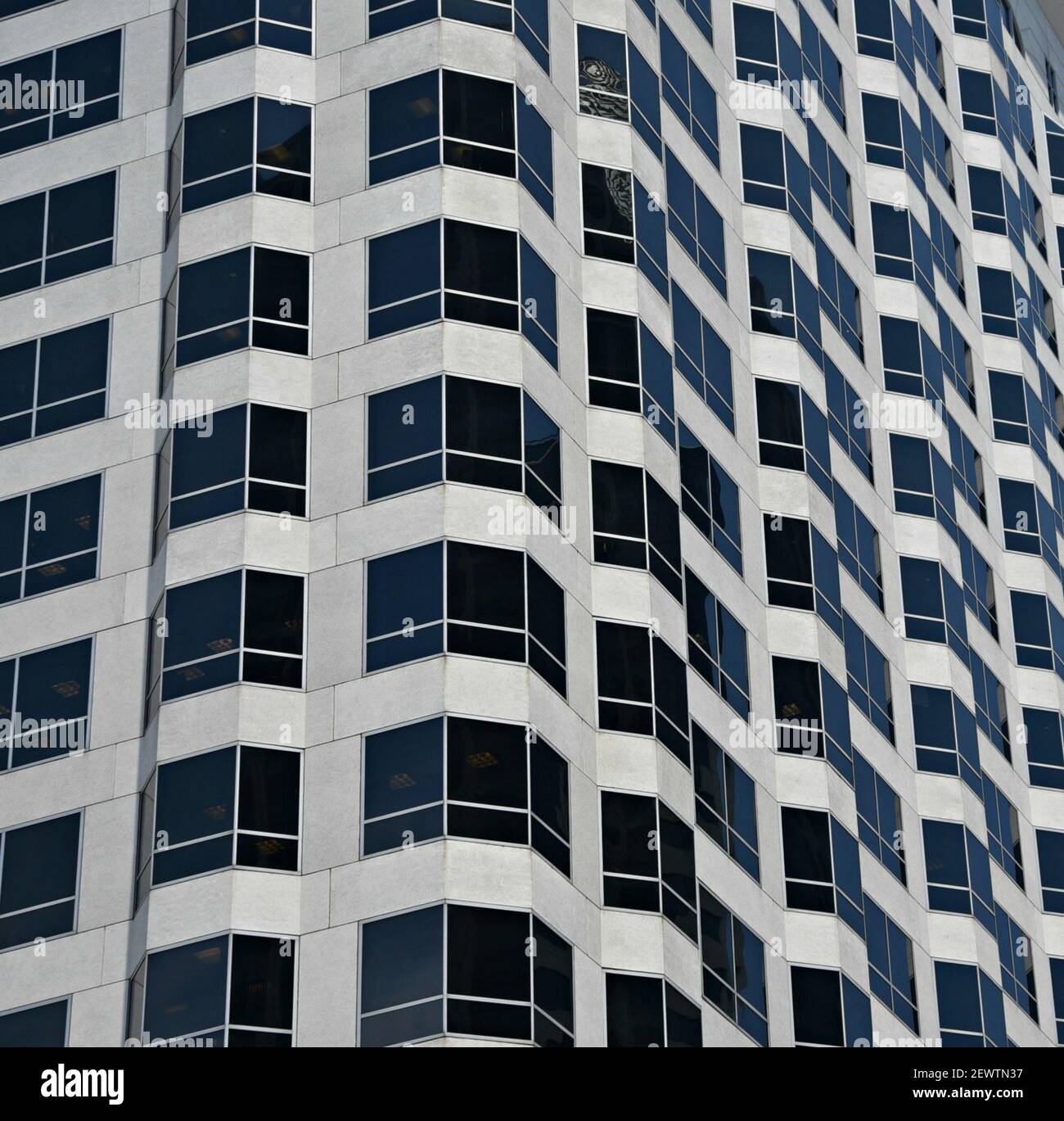 Modern design high-rise building white concrete walls and symmetrical ...