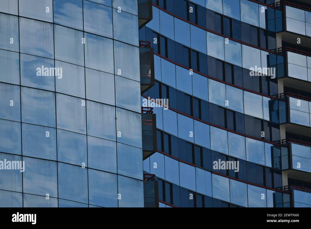 Luxury hotel high-rise building blue glass facade with reflections in ...