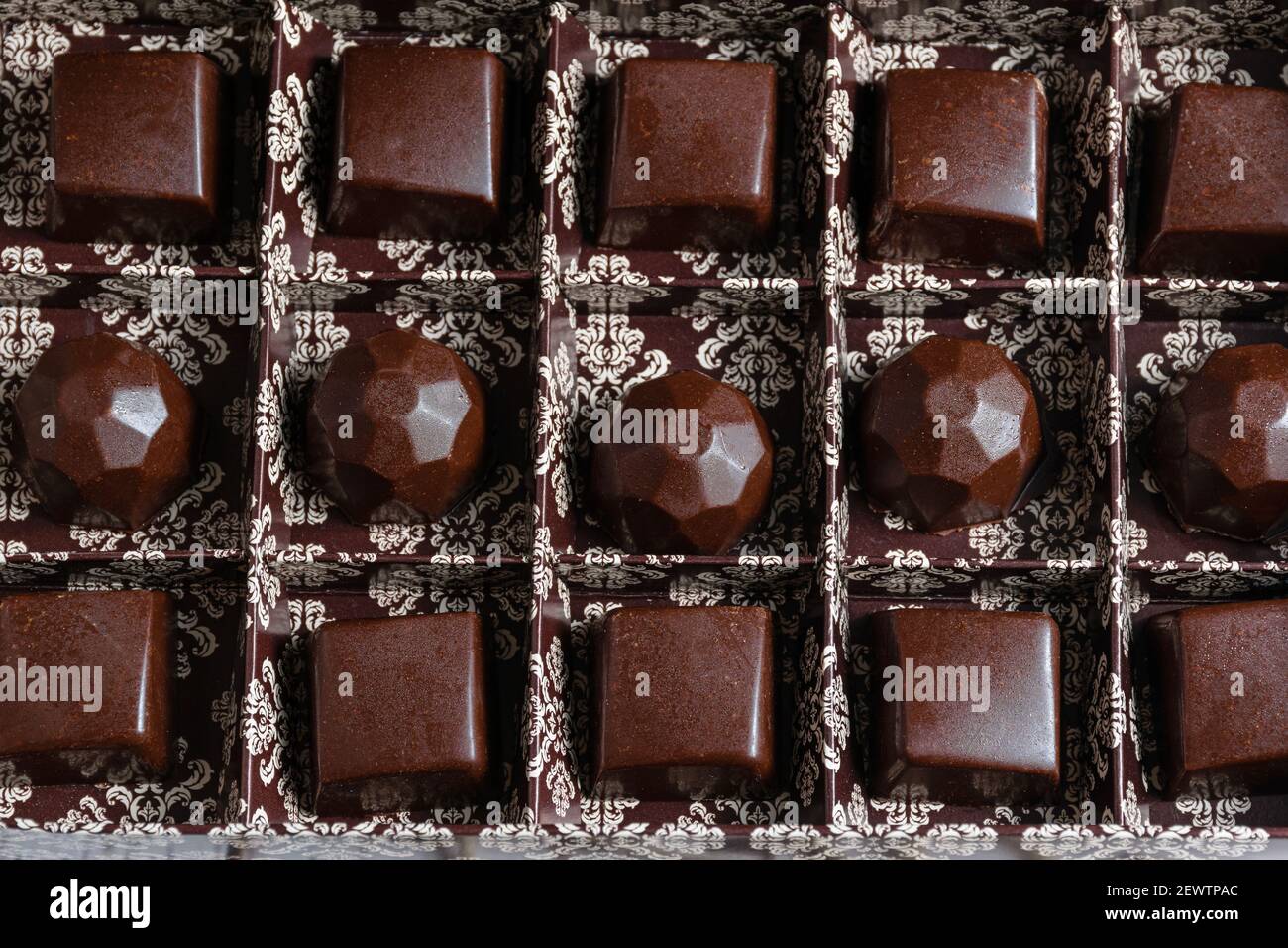 Brown box closeup with several chocolate candies Stock Photo - Alamy