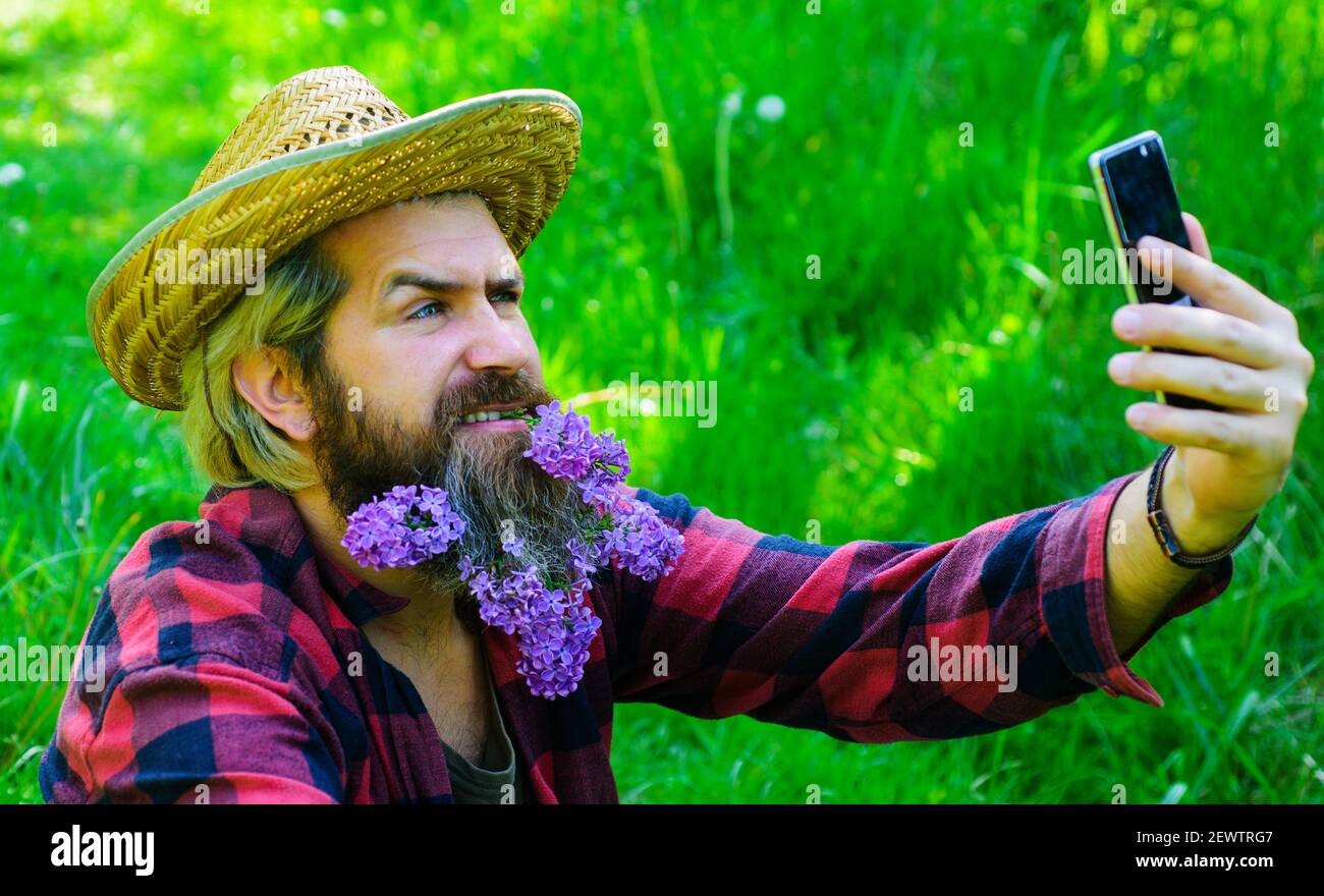 Bearded man with decorated beard making selfie on smartphone. Handsome ...