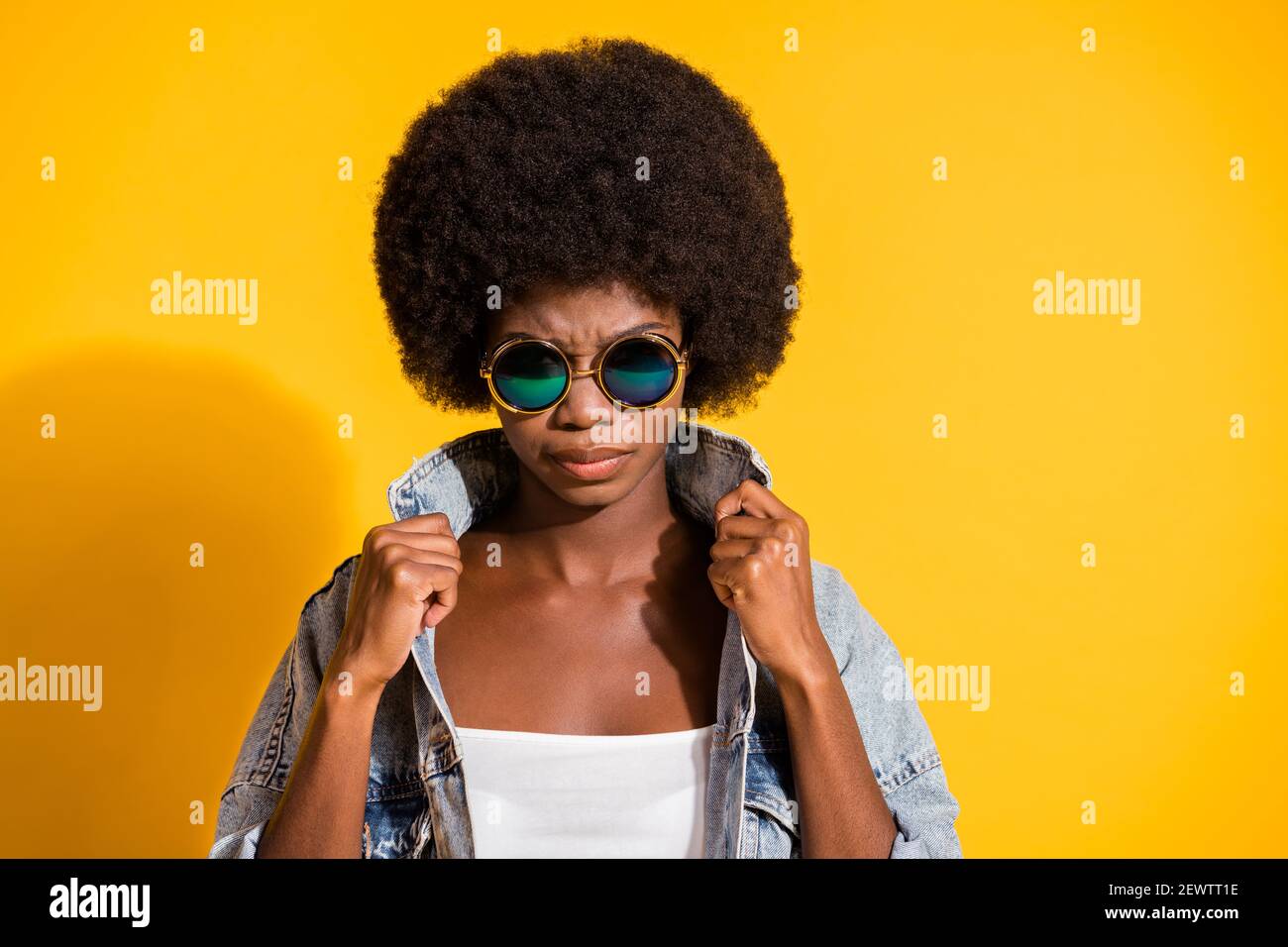 Photo of confident serious young woman wear casual jeans clothes fixing ...