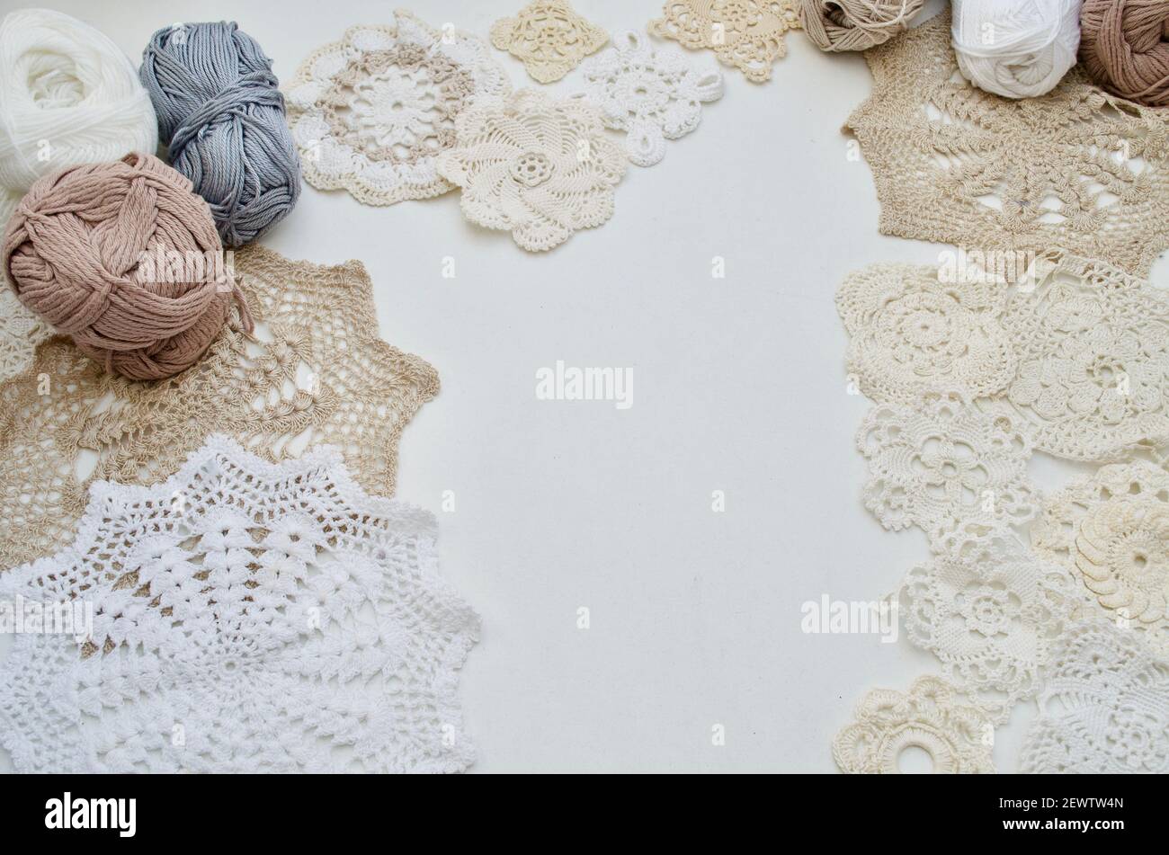 many small homemade crochet doilies on a white background Stock Photo ...