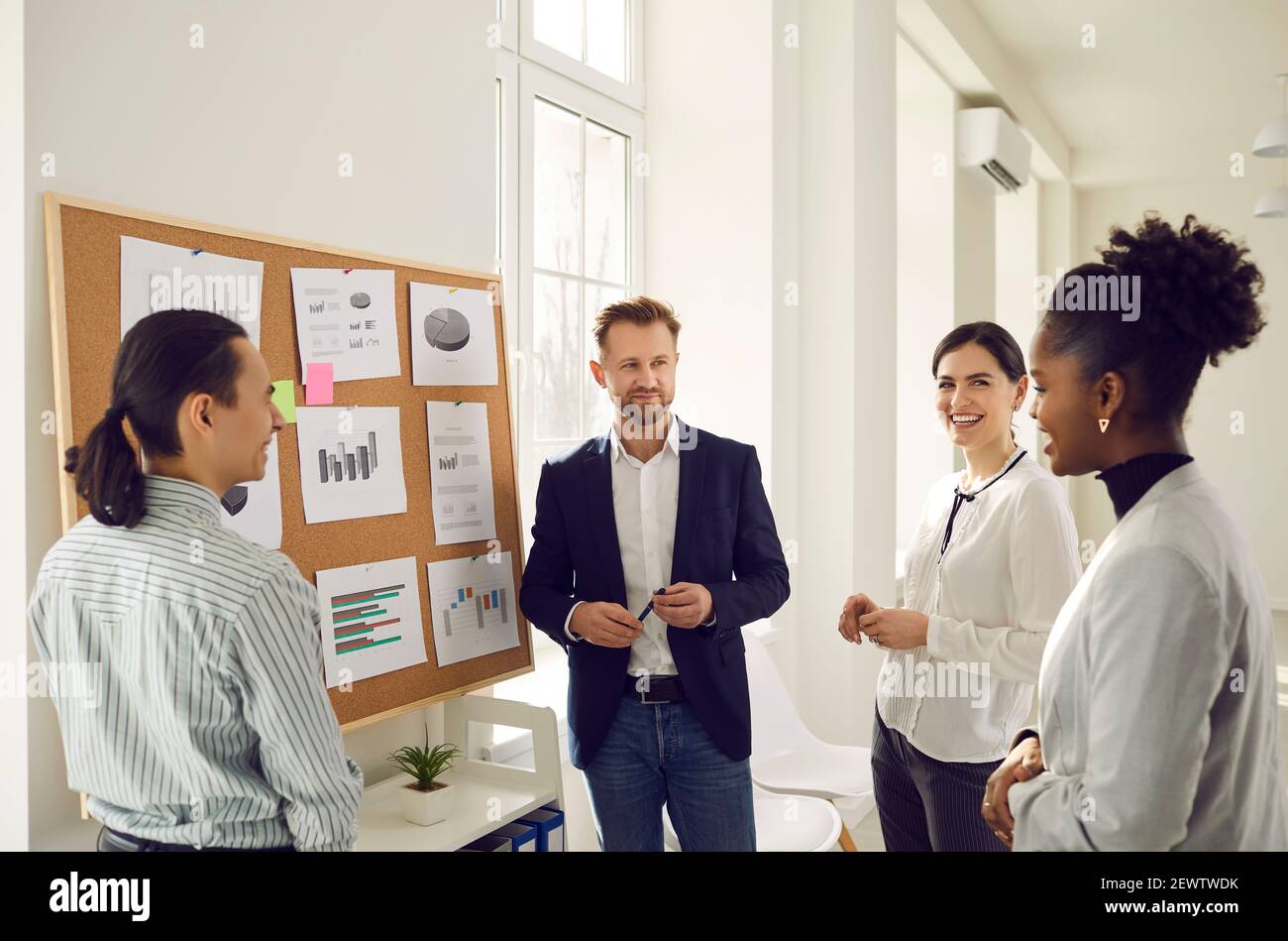 Cheerful diverse office workers discuss financial risks and analyze ...