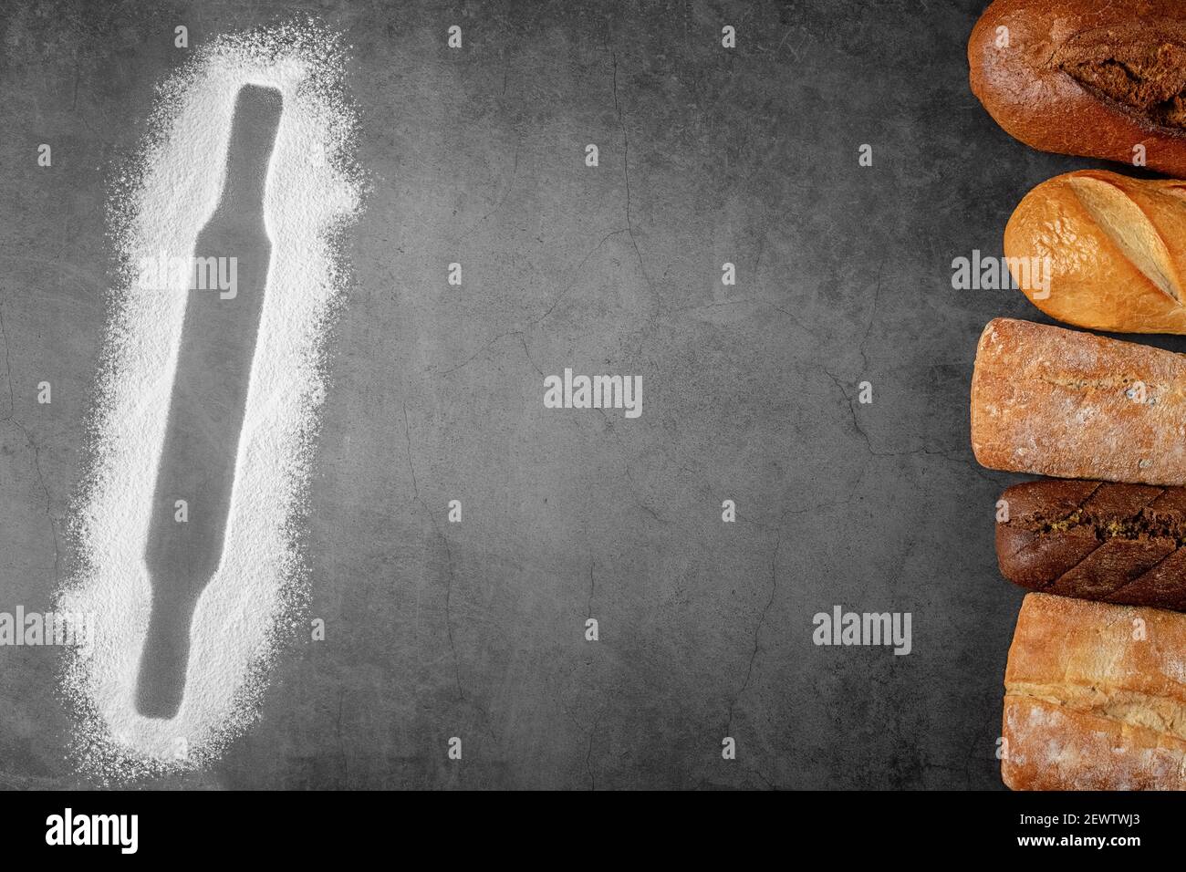 Baking dark background with copy space with various fresh baked bread ...