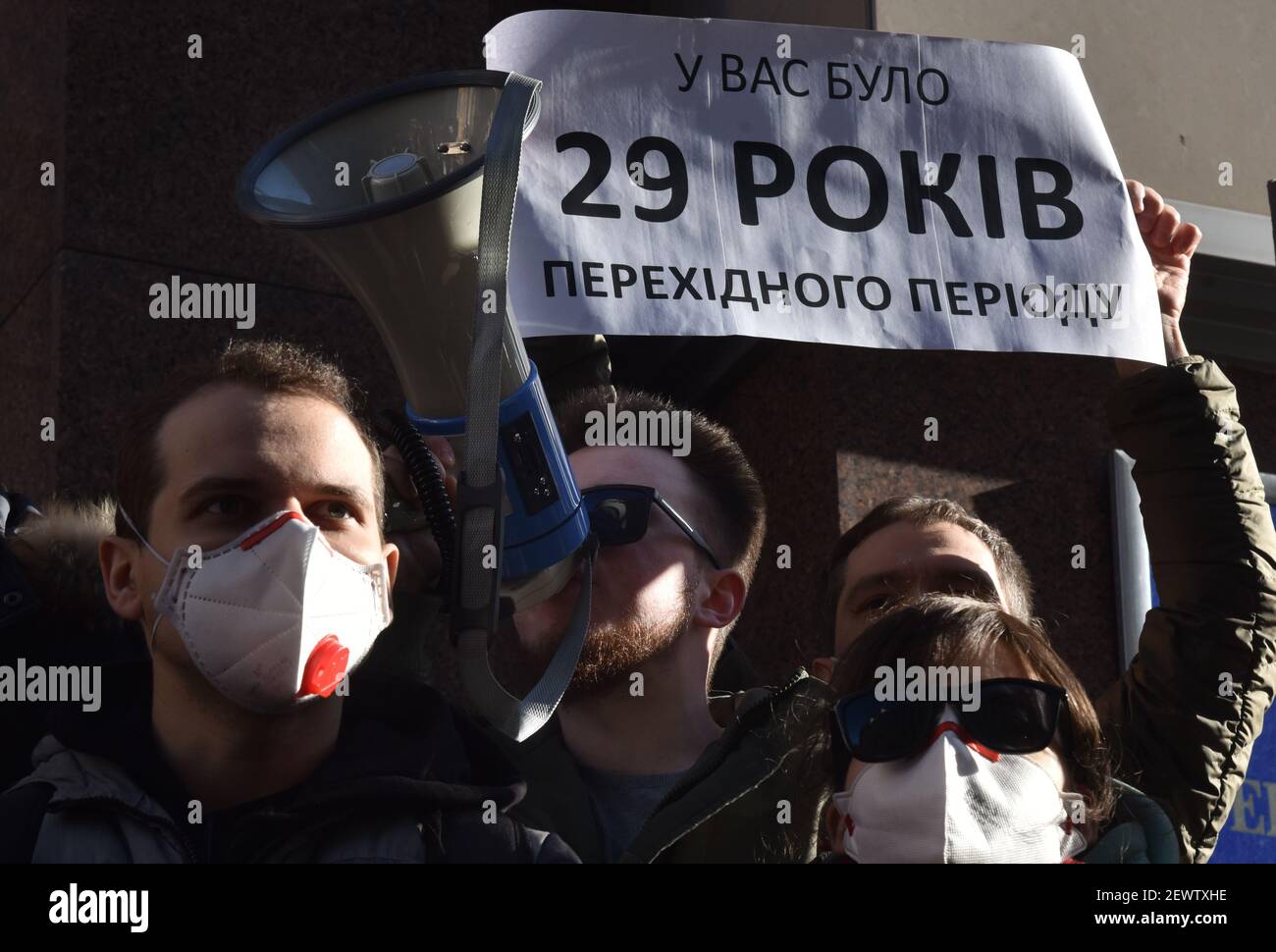KYIV, UKRAINE - MARH 03, 2021 - A public activist holds a placard with slogans during the No to ...