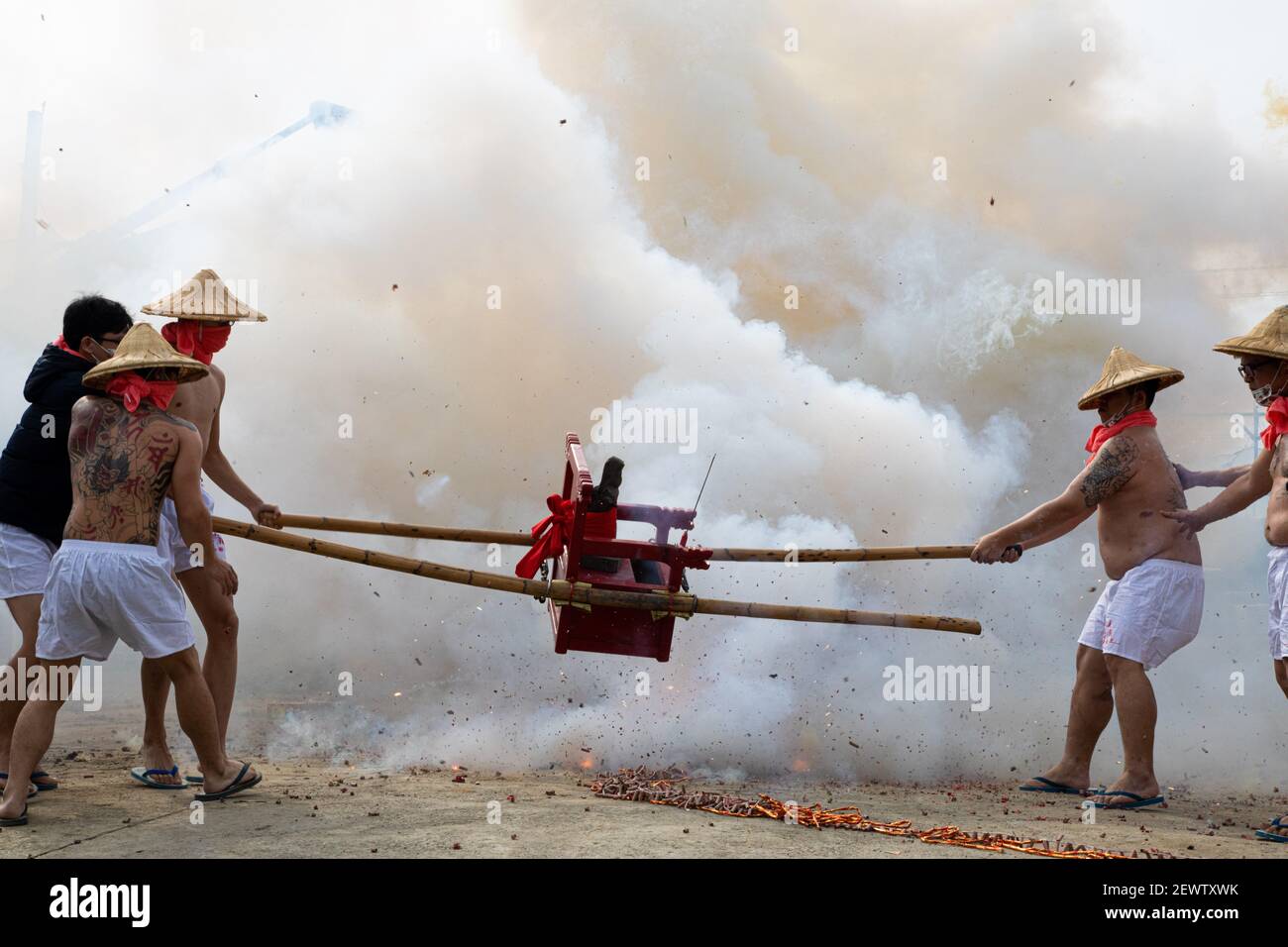Five pilgrims react to the firecrackers whilst carrying Tudigong's ...