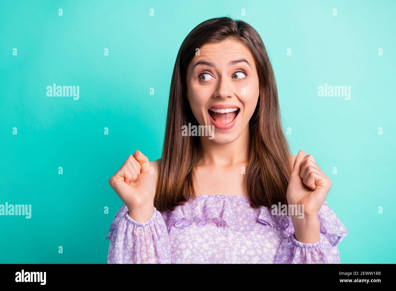 Portrait of impressed nice girl hands fists yell look empty space wear ...