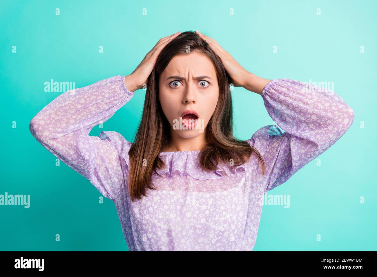 Portrait of impressed sad nice girl hand hair open mouth wear purple ...