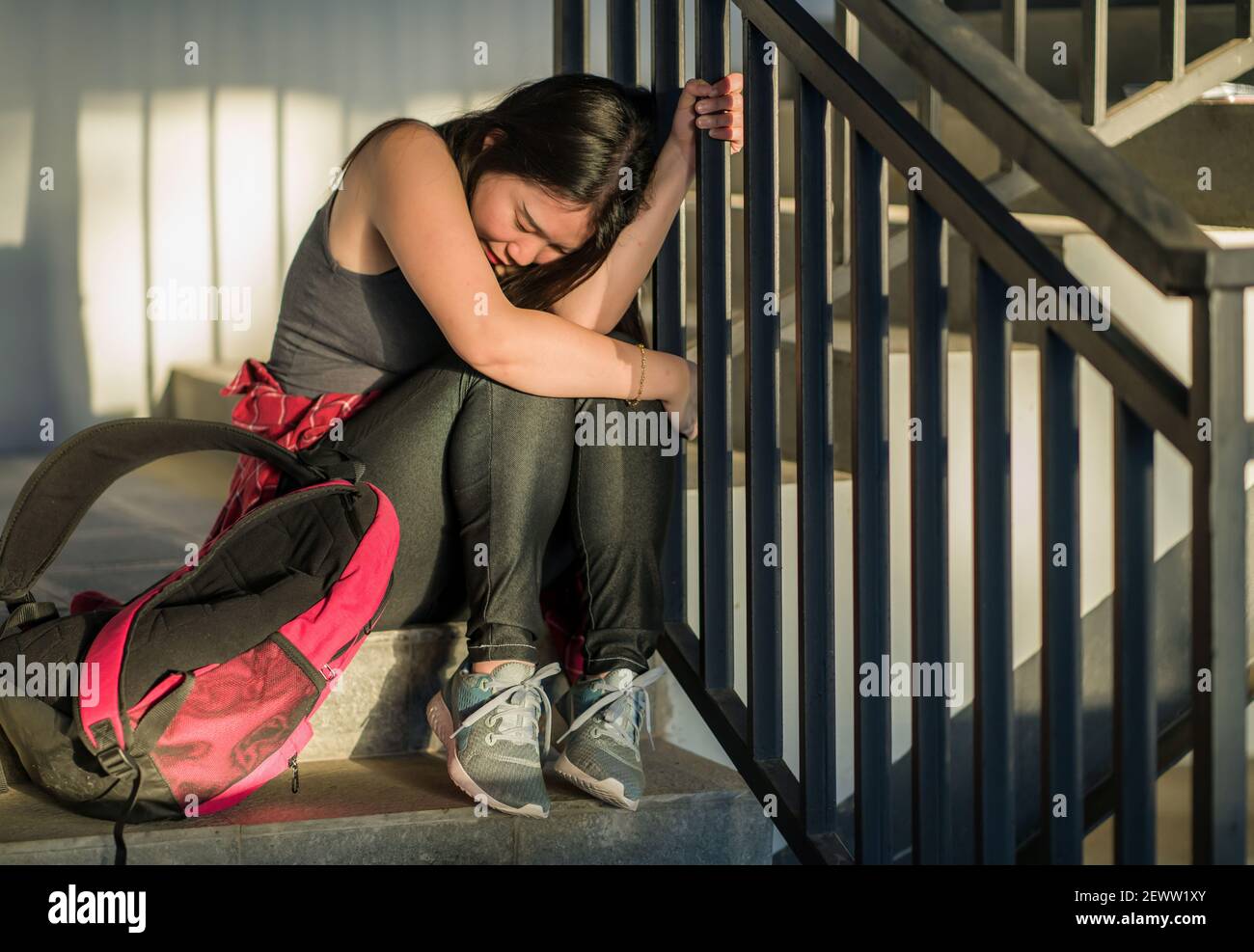 young depressed and scared Asian Japanese student girl suffering abuse ...