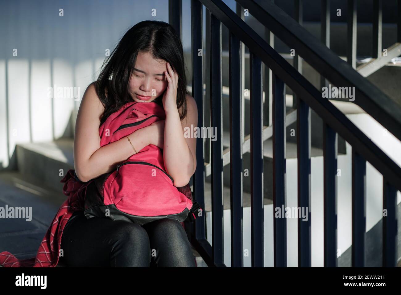young depressed and scared Asian Korean student girl suffering abuse ...