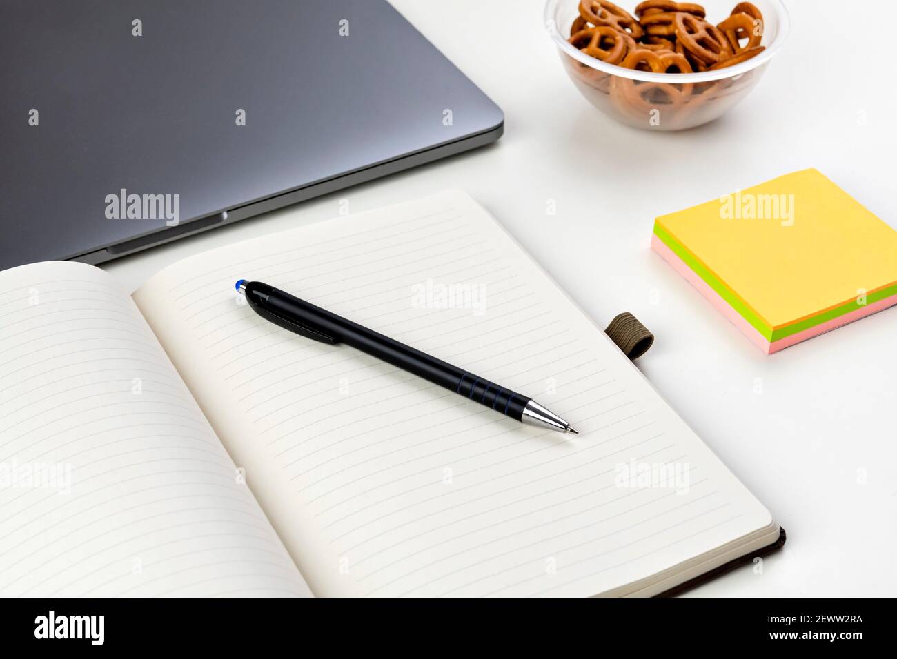 Modern white office desk table with open blank notebook, pen and other ...