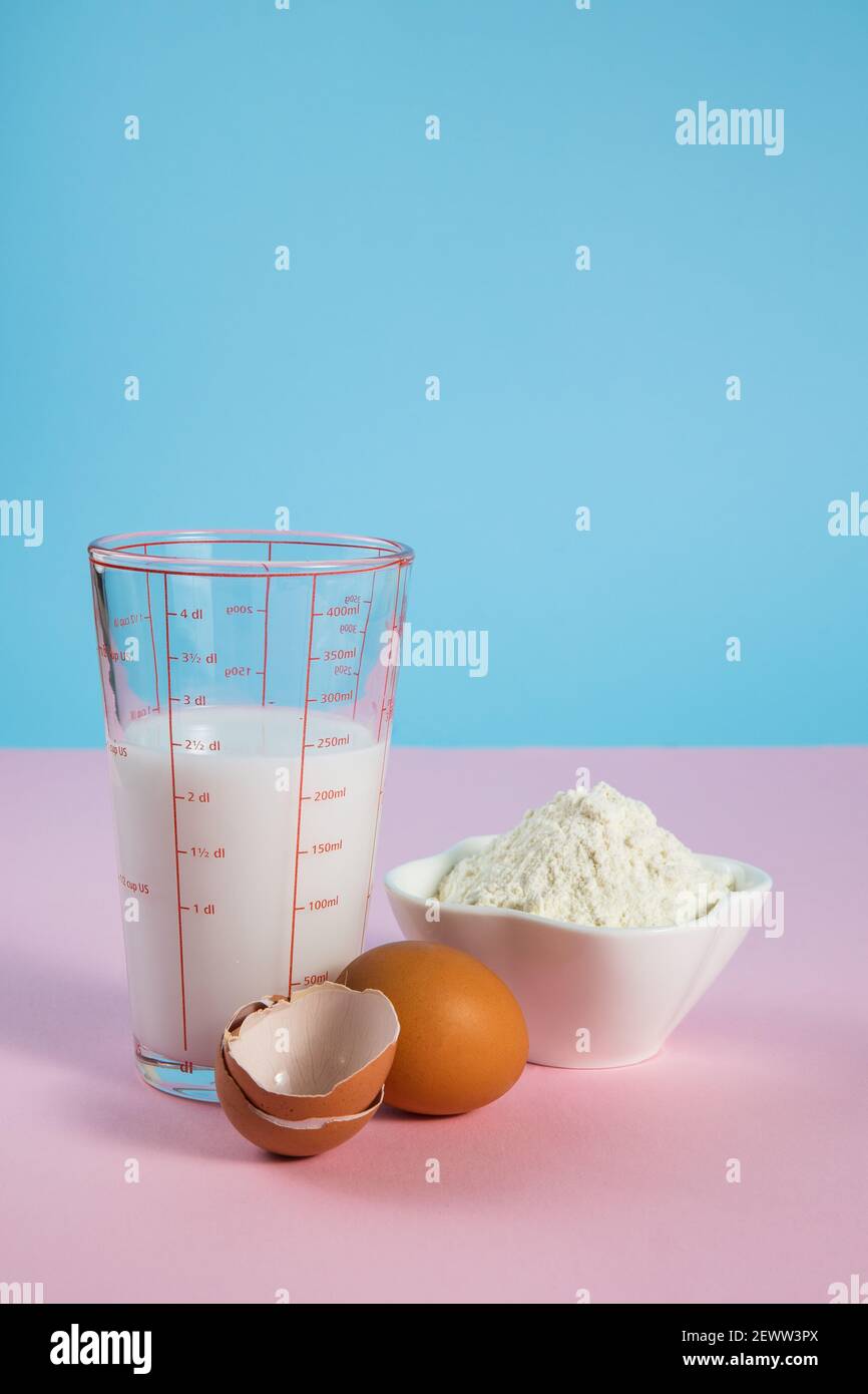 eggs milk and flour on pink and light blue background Stock Photo - Alamy