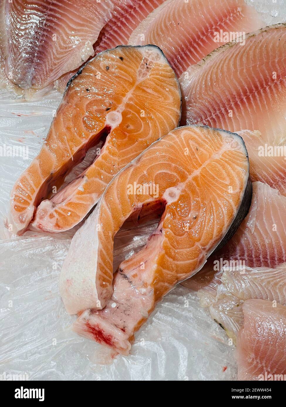 Close-up of fresh fillet of raw fish in pieces of ice. Chilled fish ...