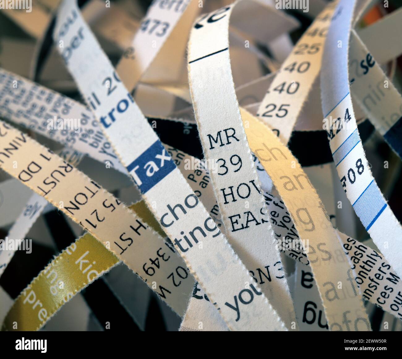 Close-up of shredded personal documents, including bank statement, tax ...