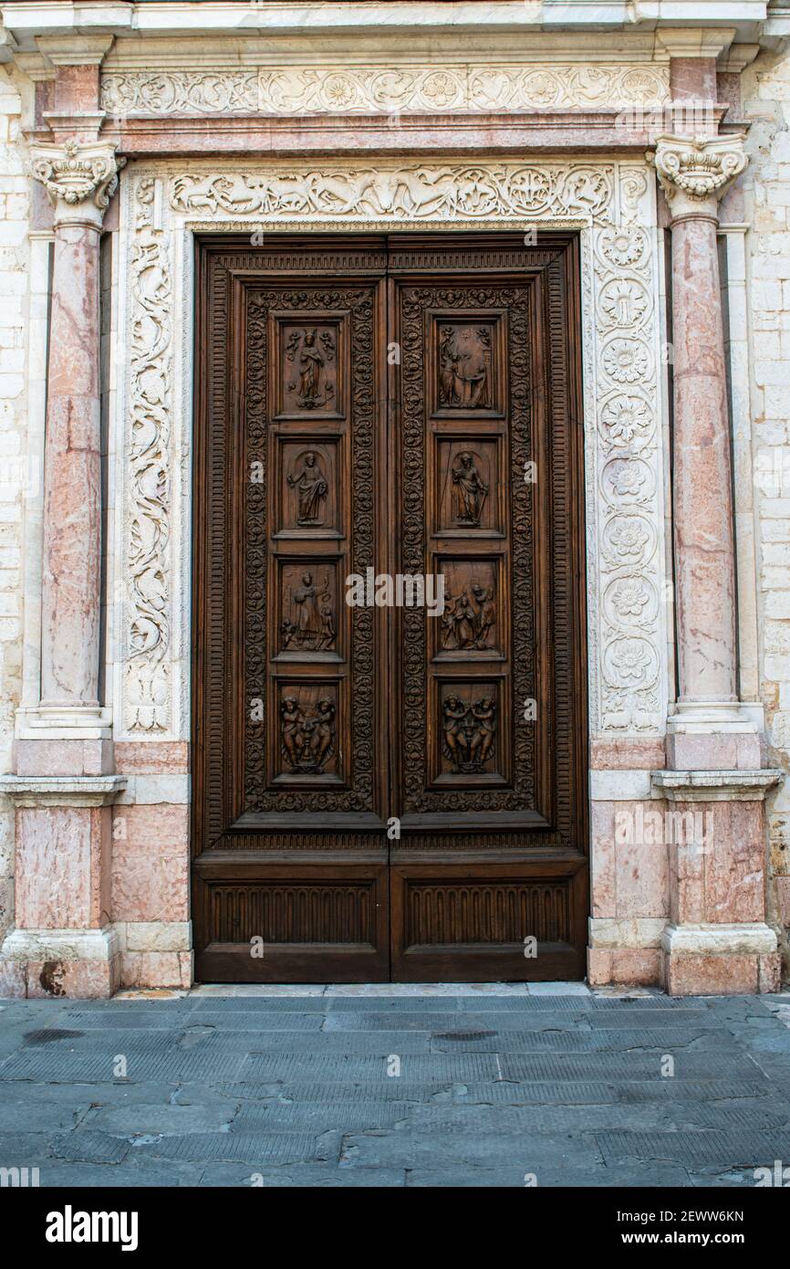 The wooden front door օf an ancient building with engraved sculptures ...