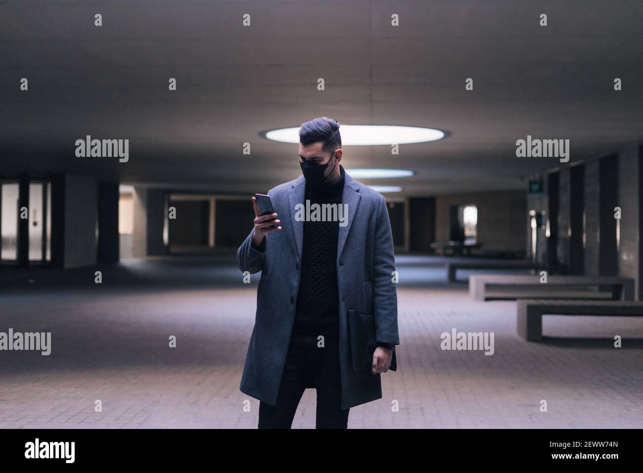 Young businessman with face mask texting with his cell phone Stock ...