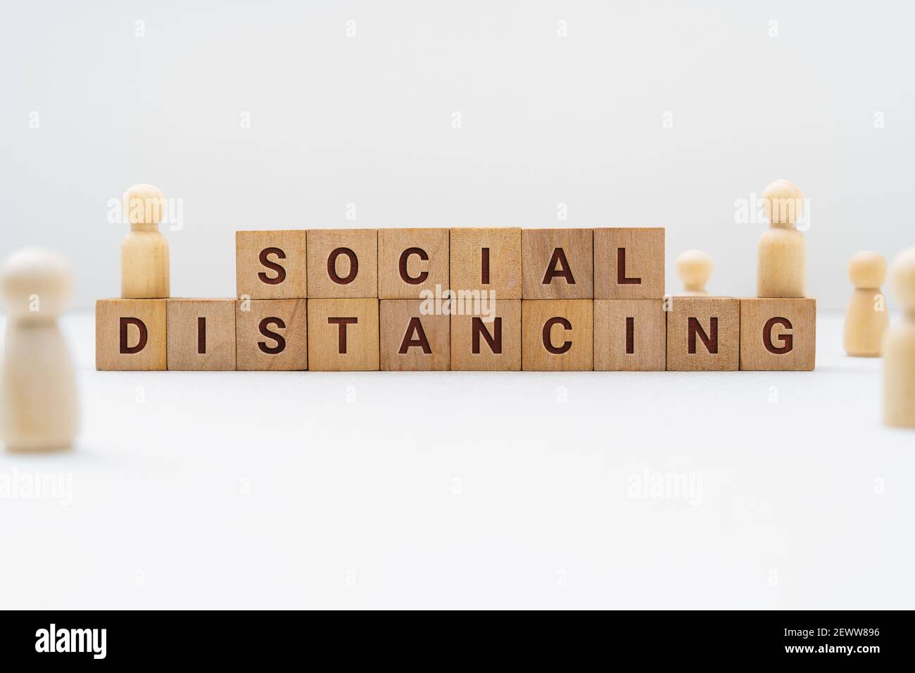 Social Distancing on Wooden Block on White Background Stock Photo - Alamy