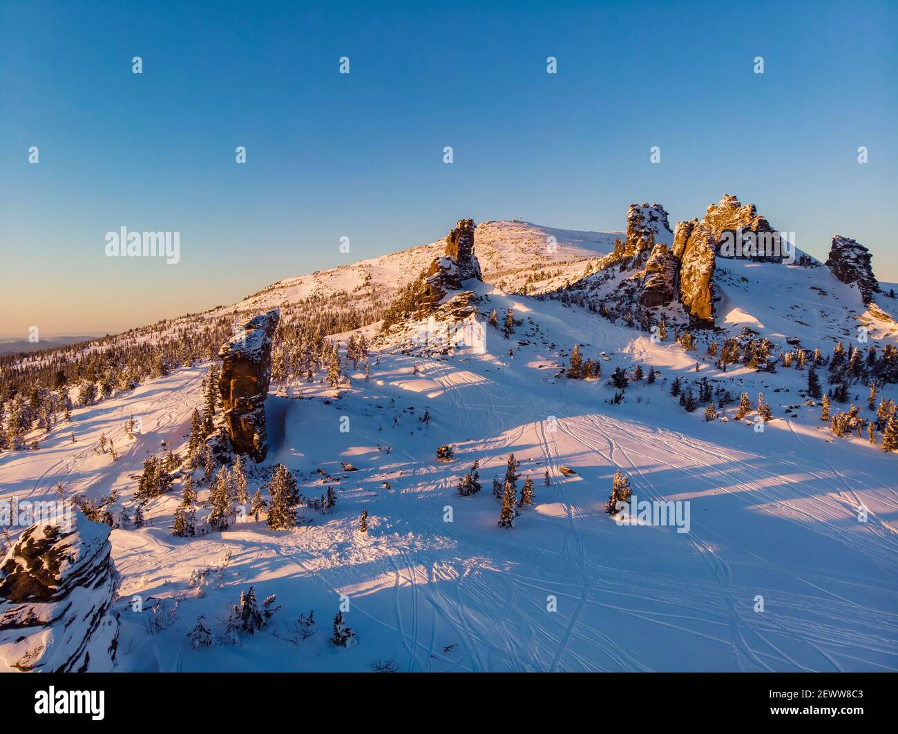 Colorful winter sunset in Sheregesh ski resort mountains with clouds ...