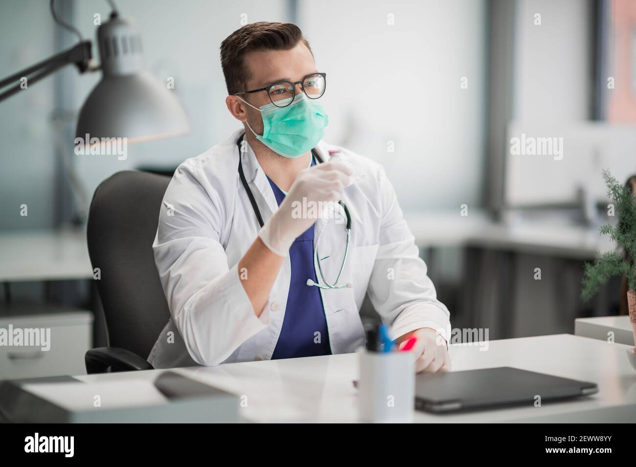 The attractive head of the medical department in his clinic shows the ...