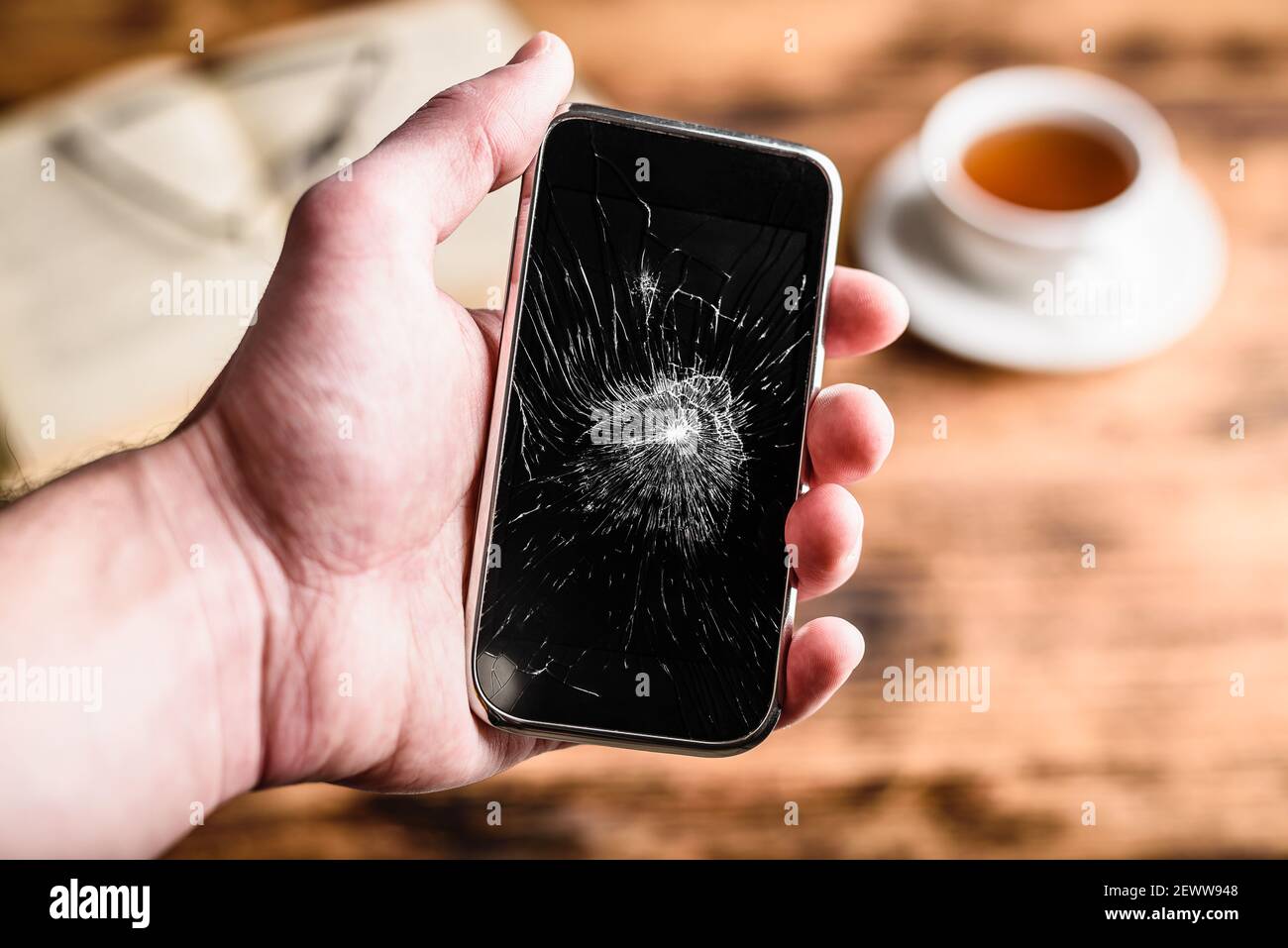 Smart cell phone with a broken screen in hand Stock Photo - Alamy