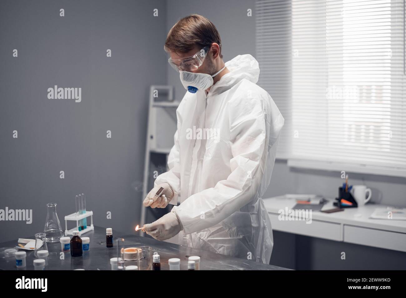 Chemical laboratory in action. A scientific researcher setting on fire ...