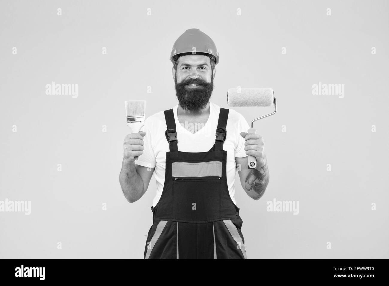 Happy brush painter in work uniform hold tools for surface painting and ...