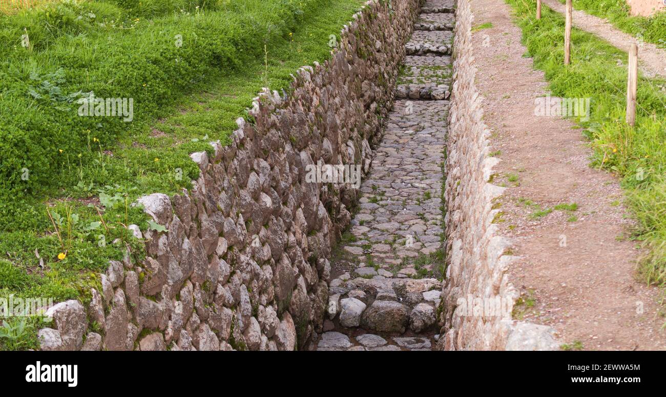 Aqueduct with inca stoneworks in cusco, peru Stock Photo - Alamy
