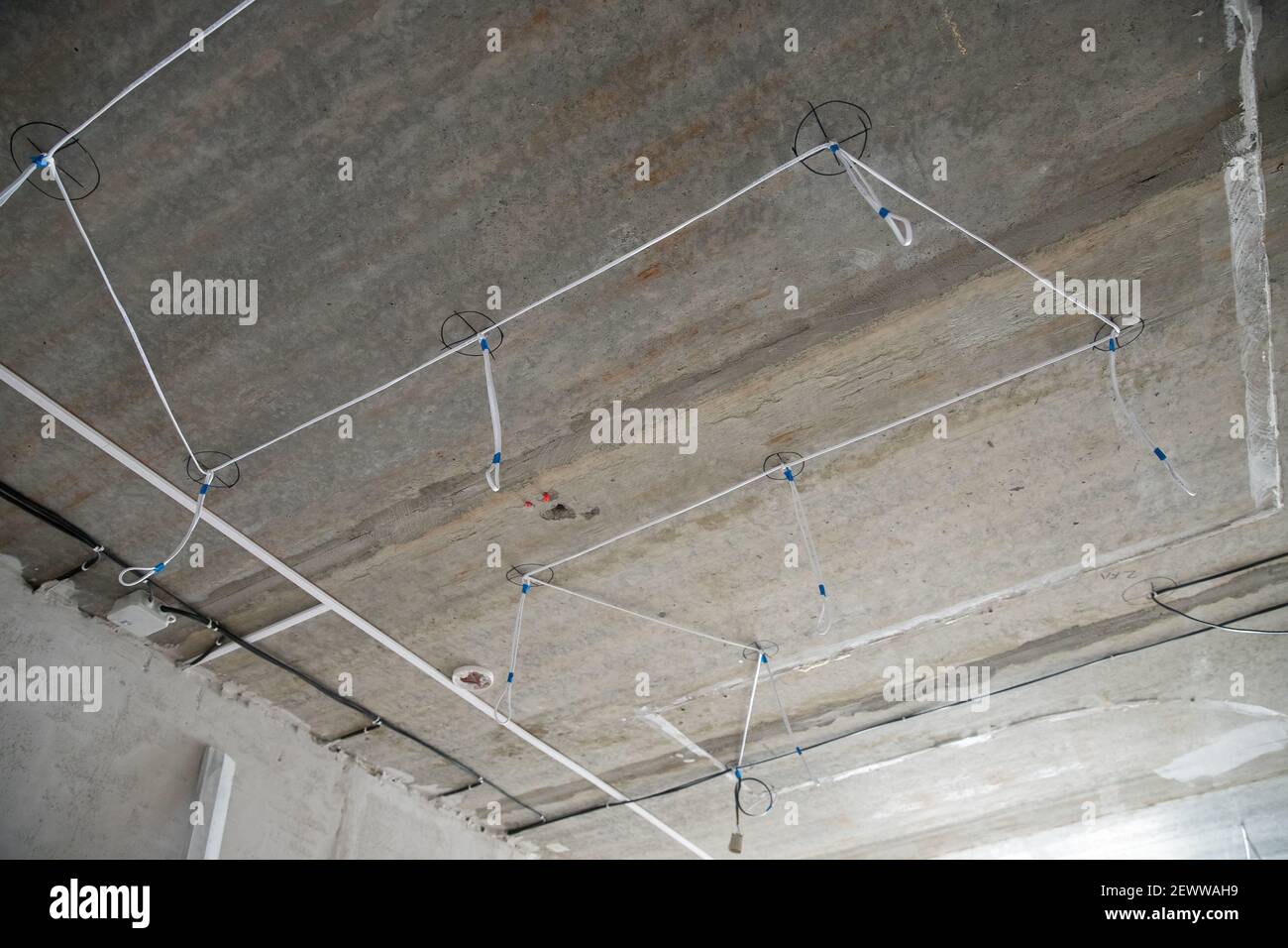 Electrical work with rough finish, electrician connects and mounts ...