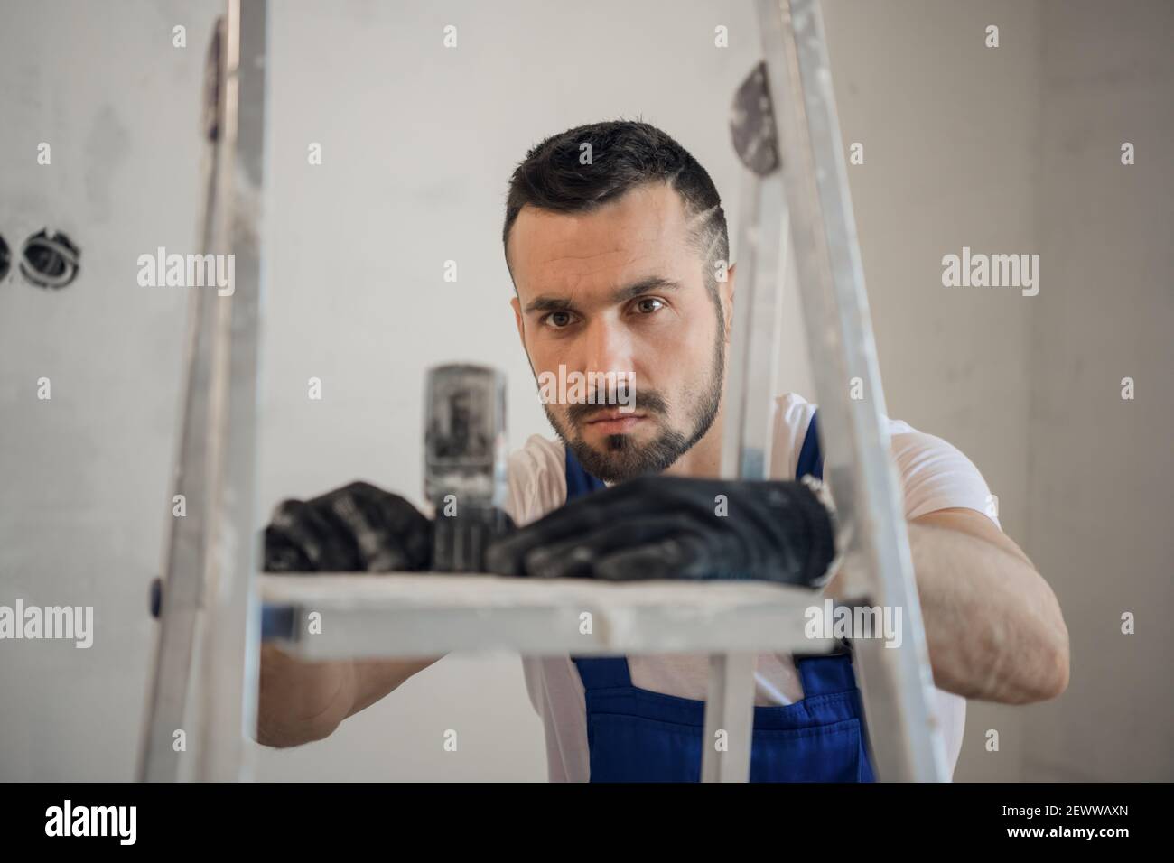 A engineer adjusts a laser ruler for marking Stock Photo - Alamy