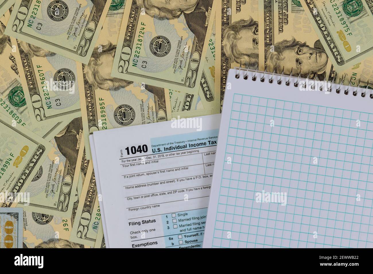 IRS form 1040 with individual income tax return of dollar bills ...