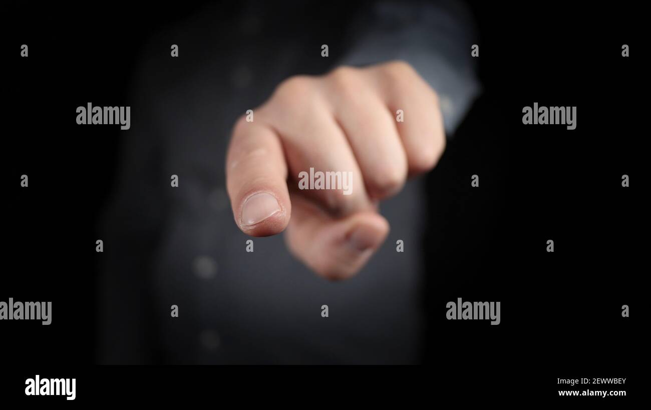 Male hand gesturing. Hand points with the index finger at the camera ...