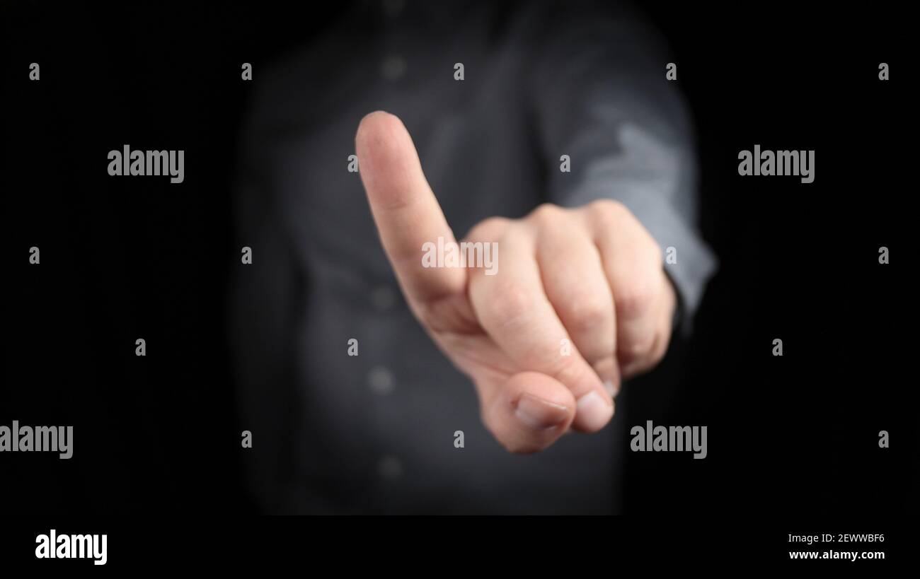 Male hand gesturing. Hand points with the index finger at the camera ...