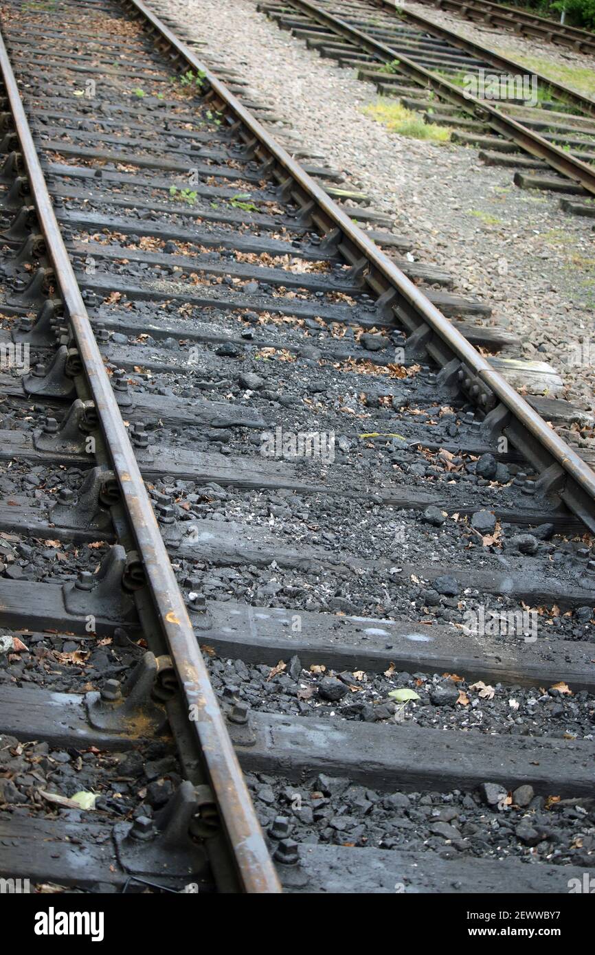 Heritage railway line tracks with wooden sleepers covered in oil, rusty ...